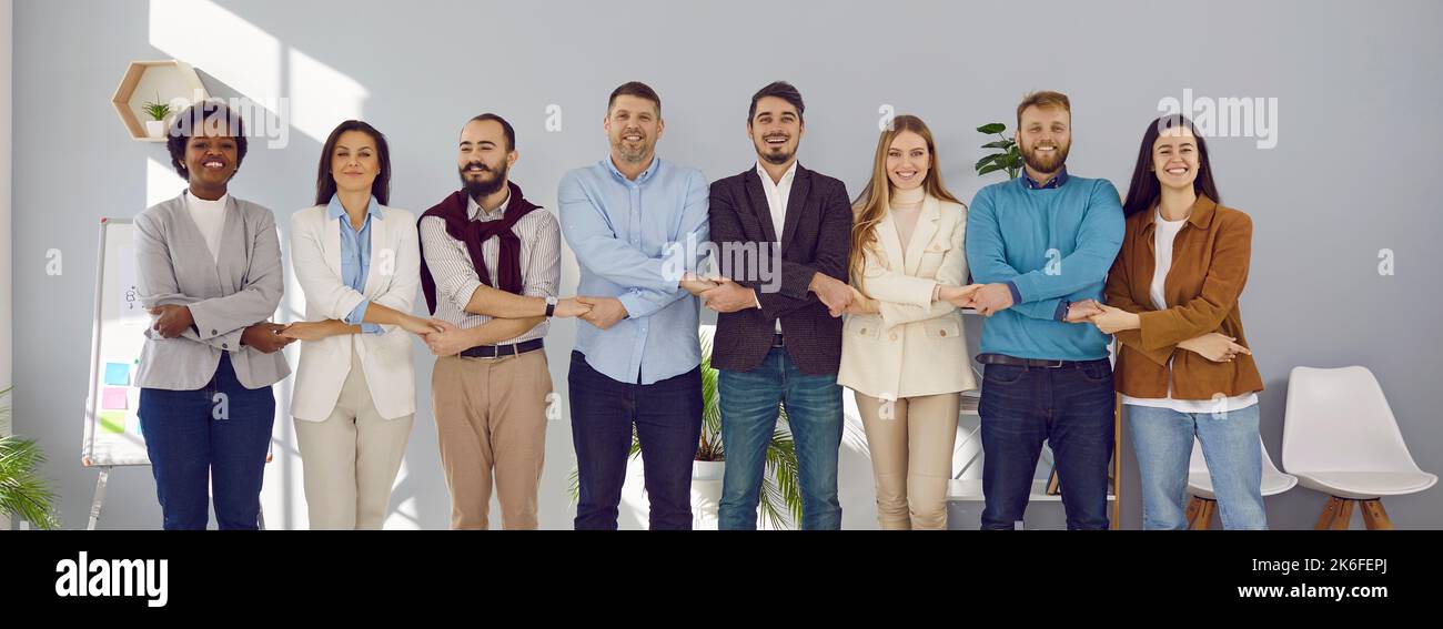 Successful and friendly group of business colleagues standing together ...