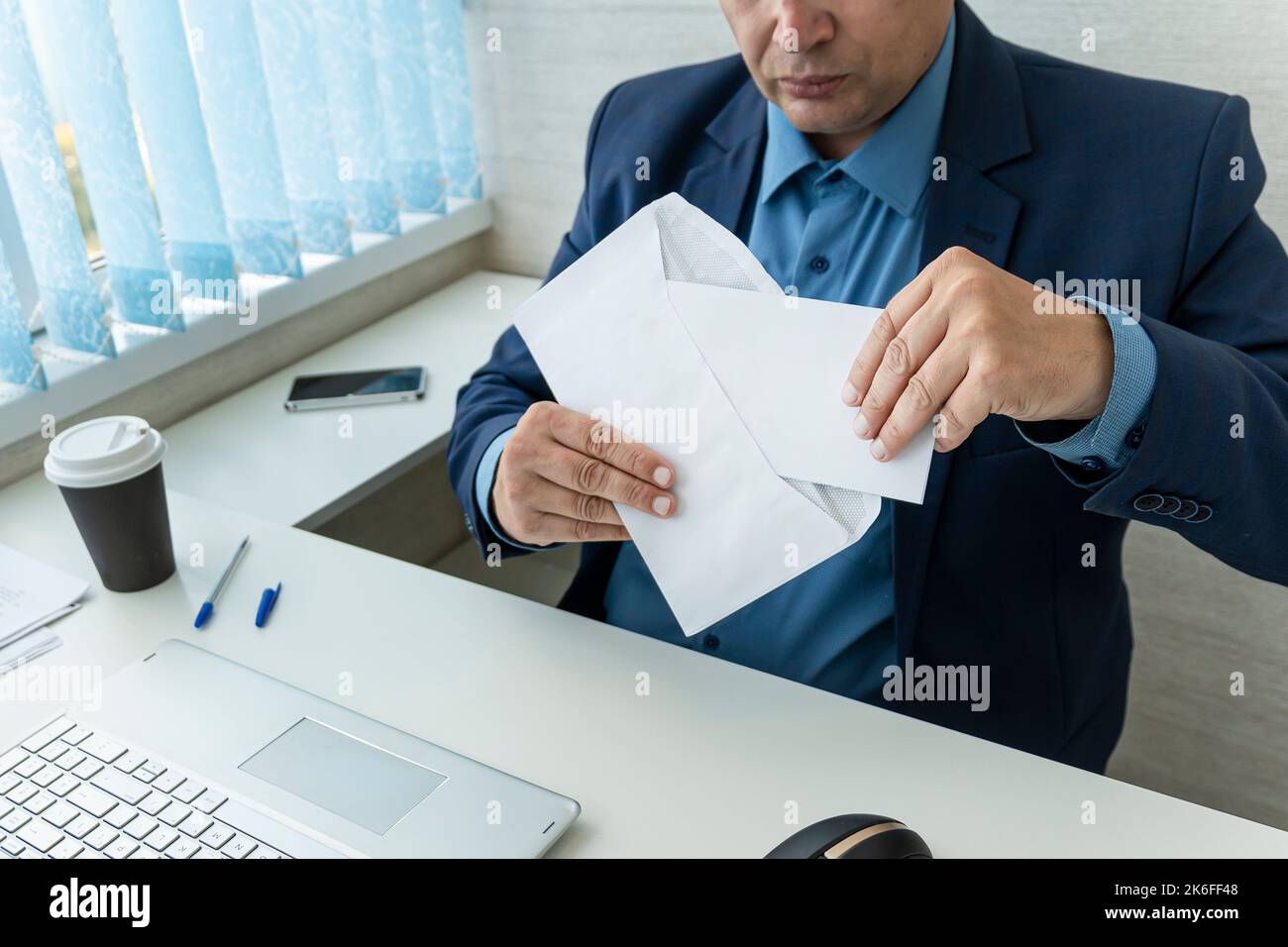 Crop close up of male employee or CEO sit at table open envelope with ...