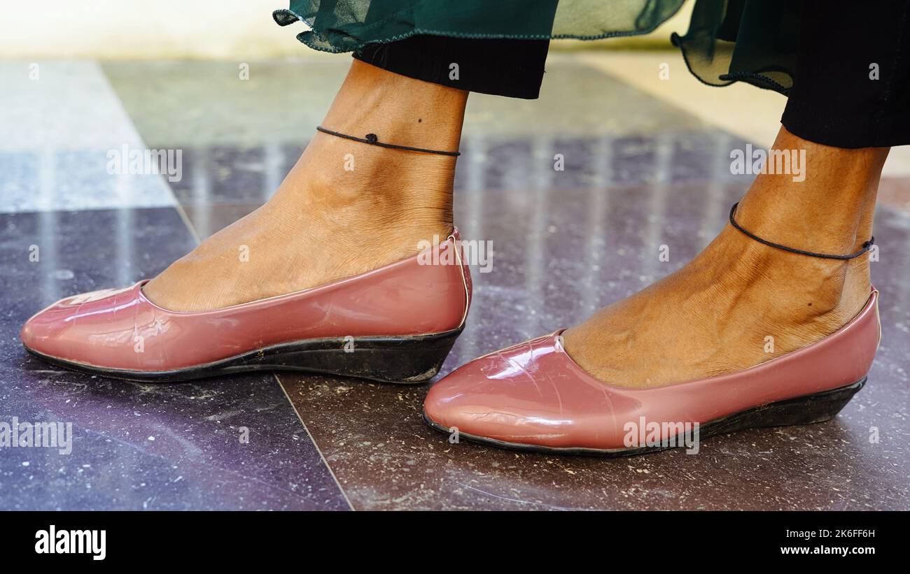 Close up of woman legs with leather shoe walking in the living room at ...