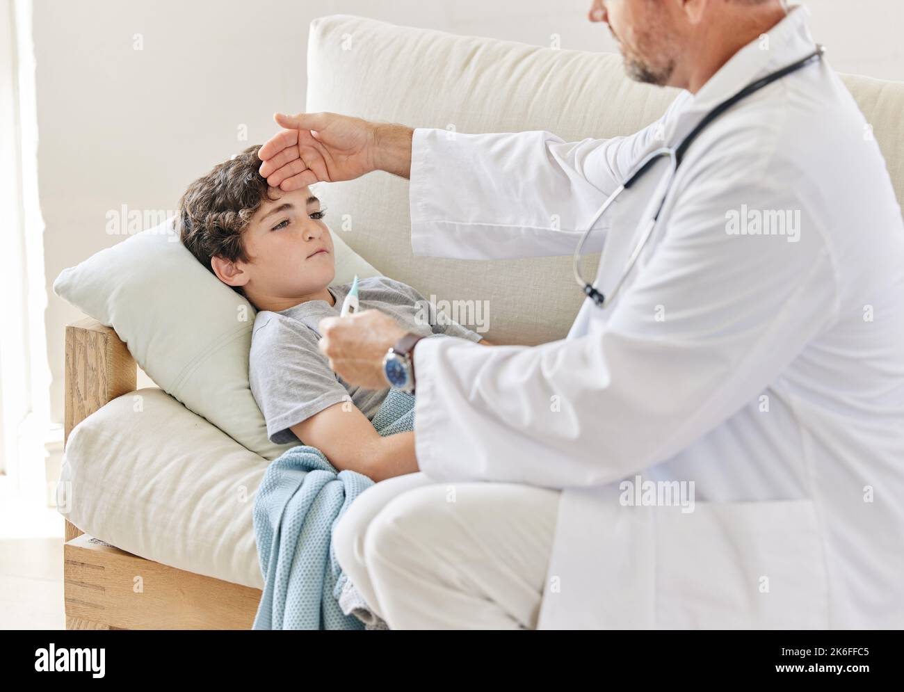 He got here just in time. a male doctor taking a little boys ...