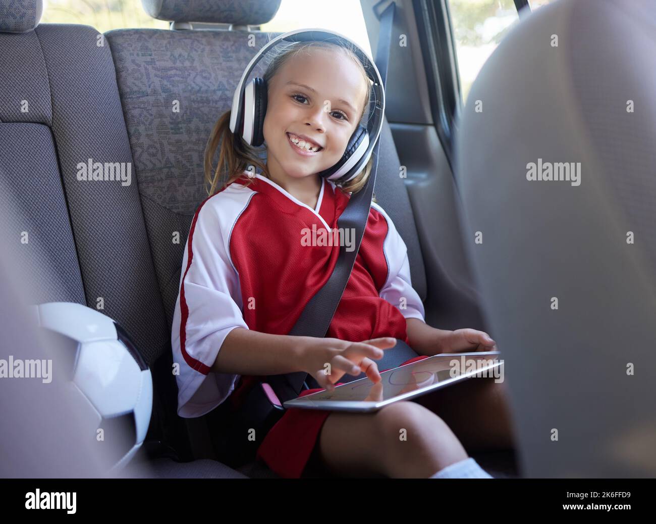 Soccer, car and girl with tablet for music traveling to football ...