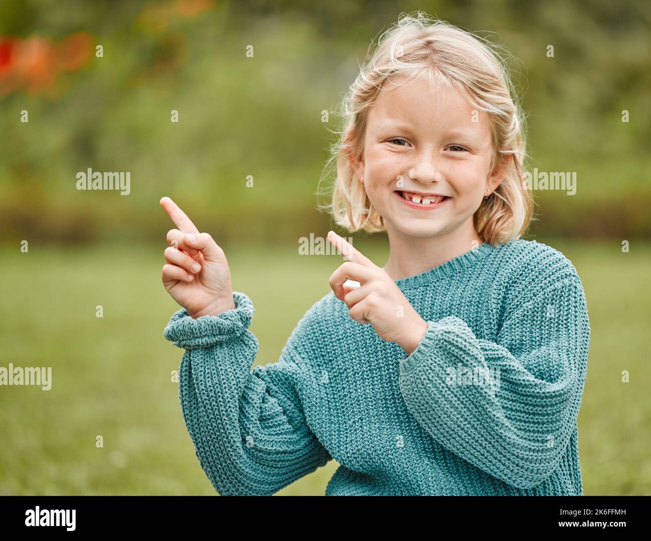 I have something cool to show you. an adorable little girl pointing at ...