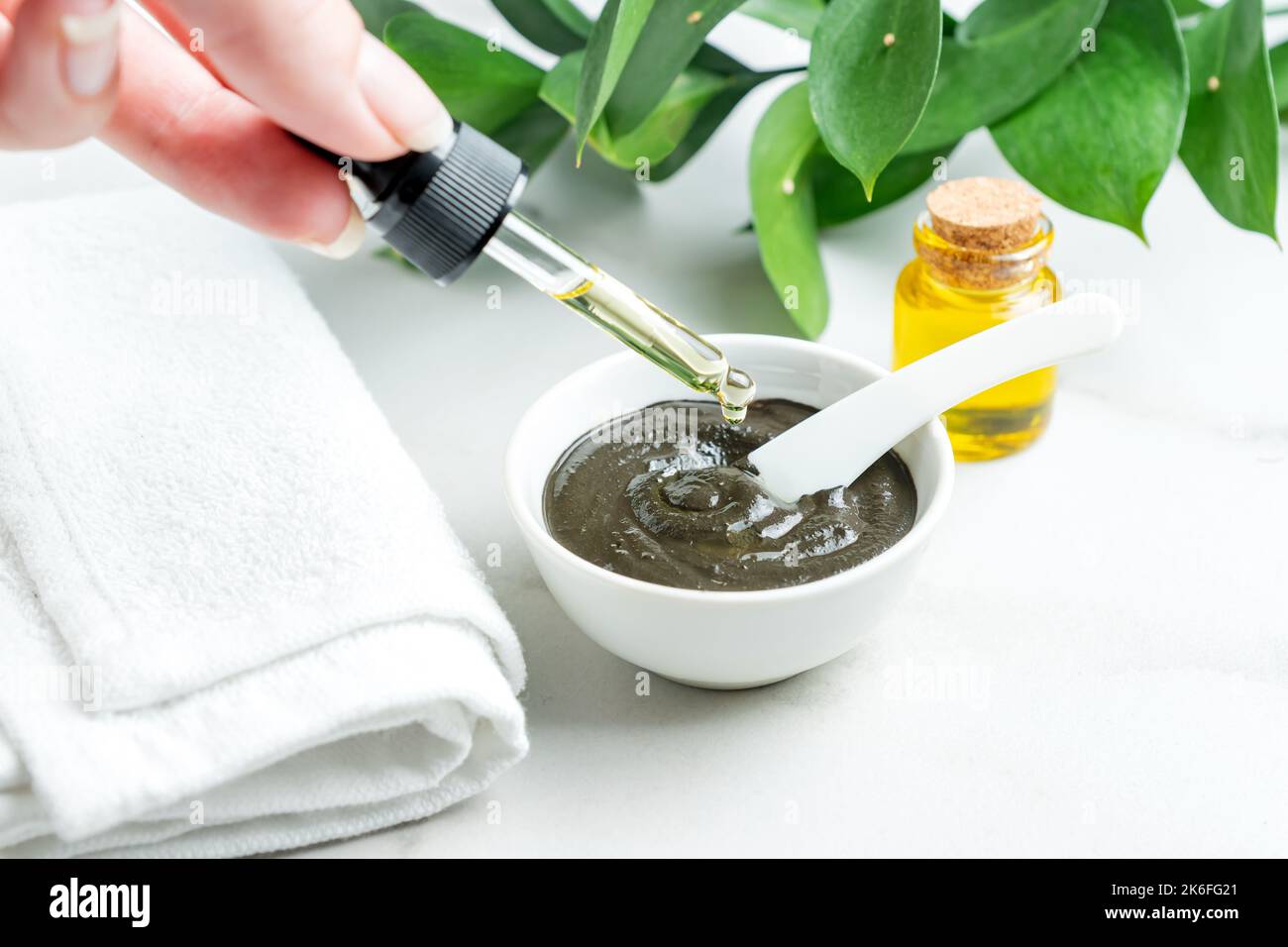 Enreaching black clay homemade mask with essential oil. Spa procedures ...