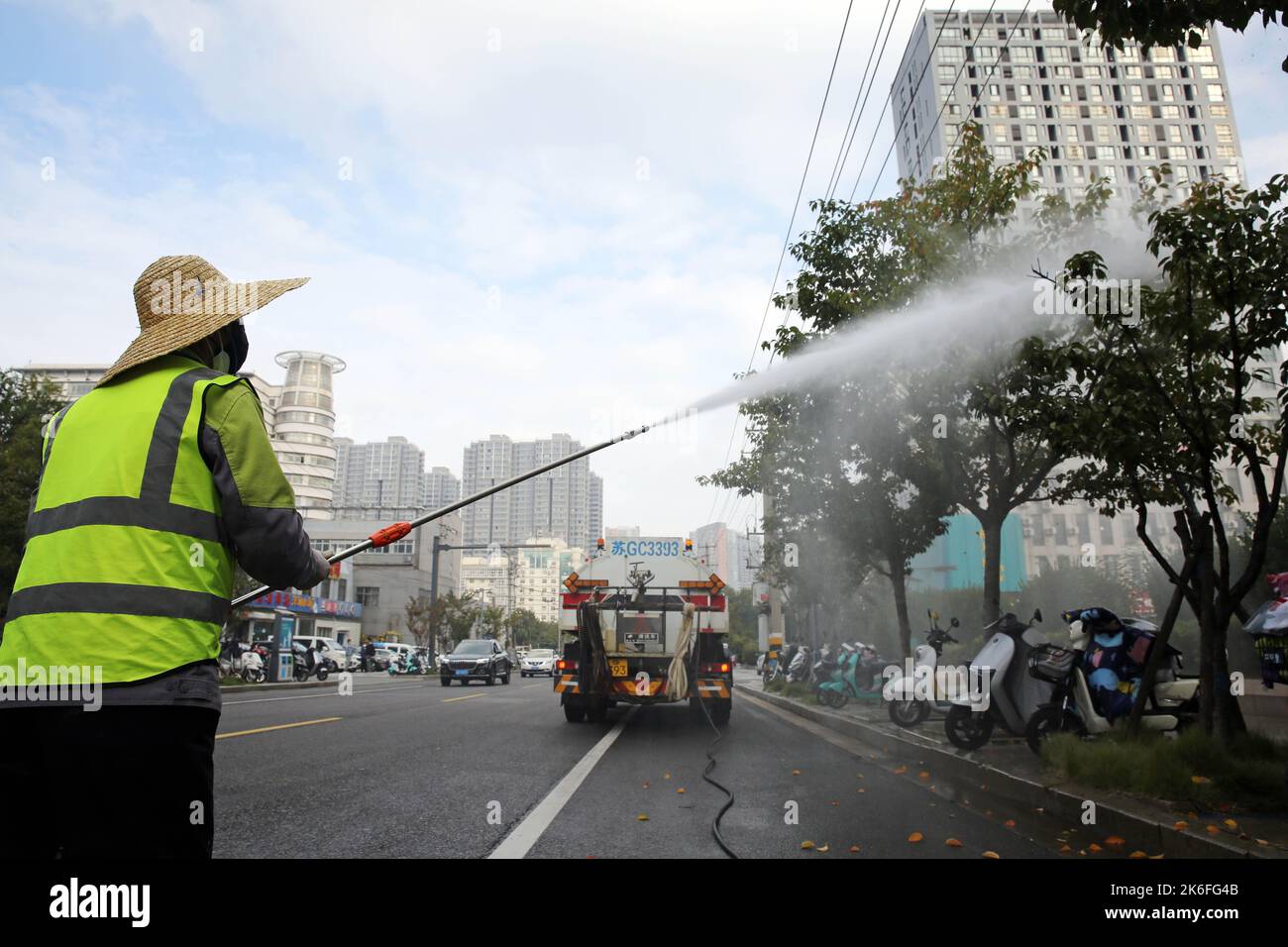 LIANYUNGANG, CHINA - OCTOBER 14, 2022 - Green workers spray trees along ...