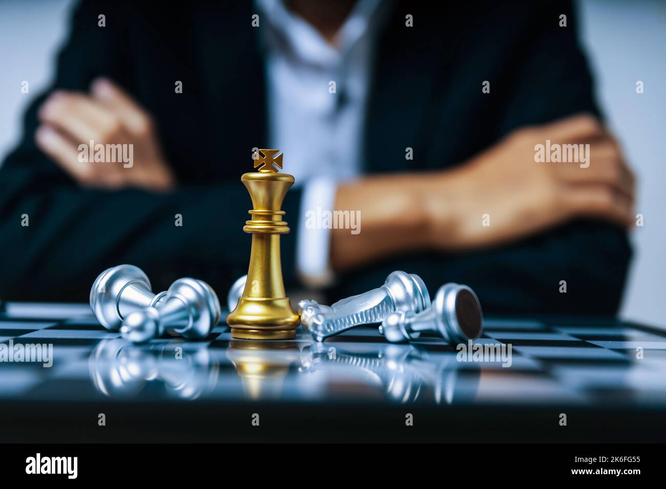 Team leader. golden king with silver chess piece on chess board game ...