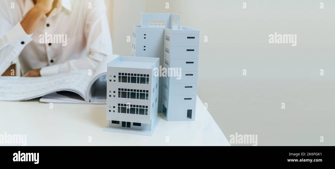 panoramic wide banner with copy space. building model on workplace desk ...