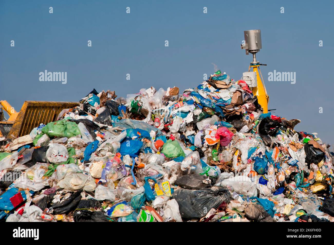 Municipal waste landfill. Workers with trucks and bulldozers at work in ...