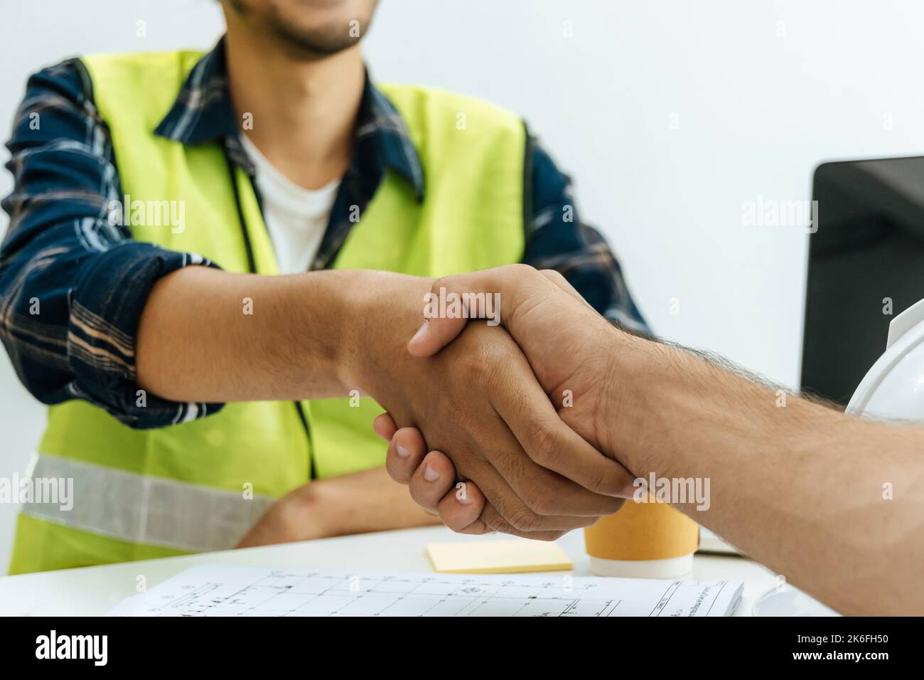 group of architect, engineer construction worker team hands shaking ...