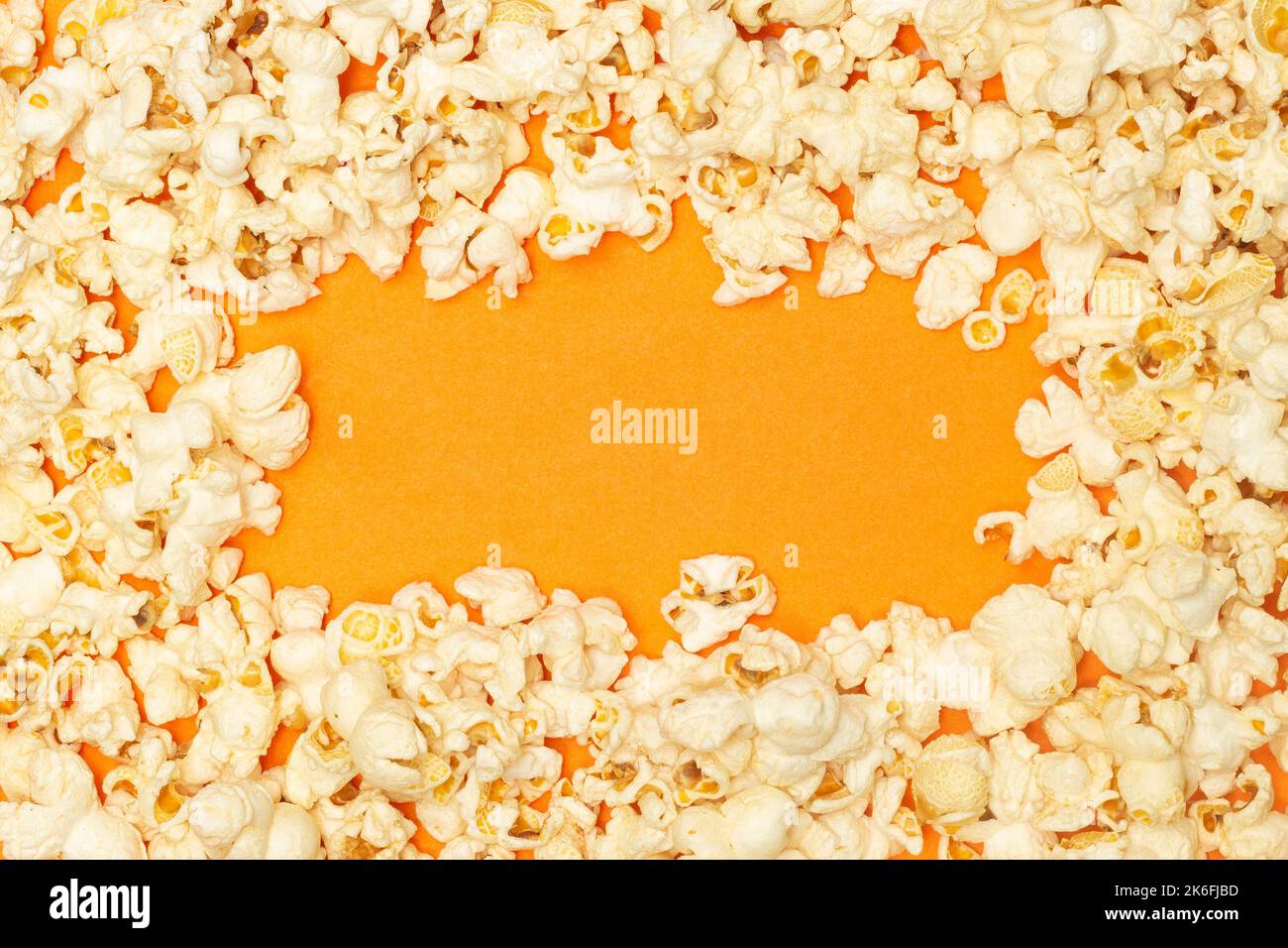 Snack concept, Sweet popcorn with empty space in circle shape of orange ...