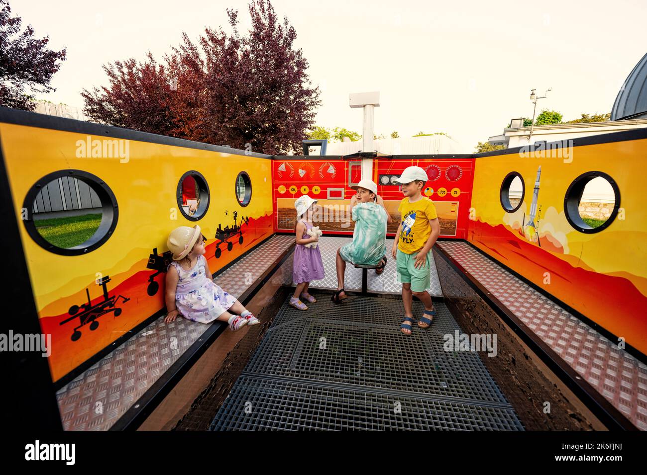 Children looking through the periscope inside moon rover outdoor ...