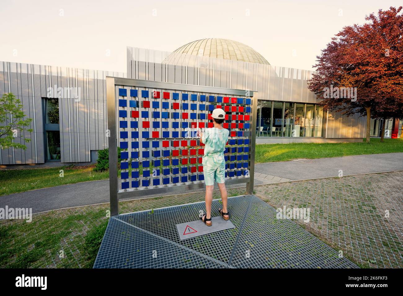 Boy making heart from steel cubes mosaics at observatory park in ...