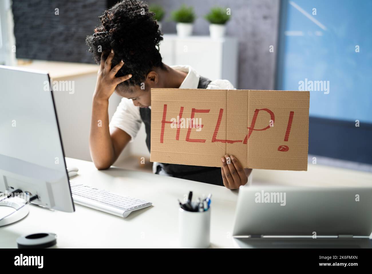 Upset Young African Woman Holding Cardboard With Help Text In Office ...