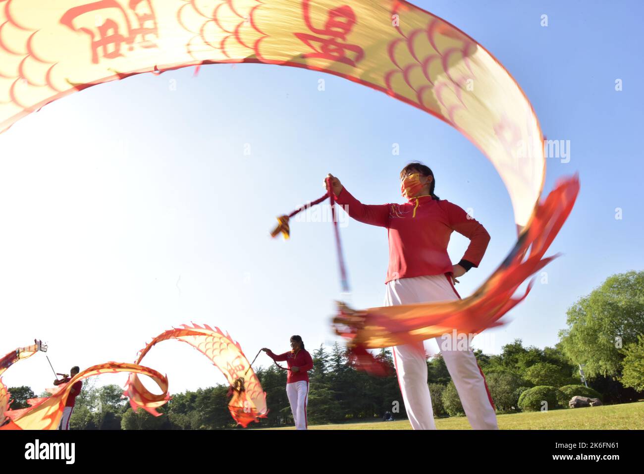 HEFEI, CHINA - OCTOBER 13, 2022 - Dragon dance lovers wave streamers as ...