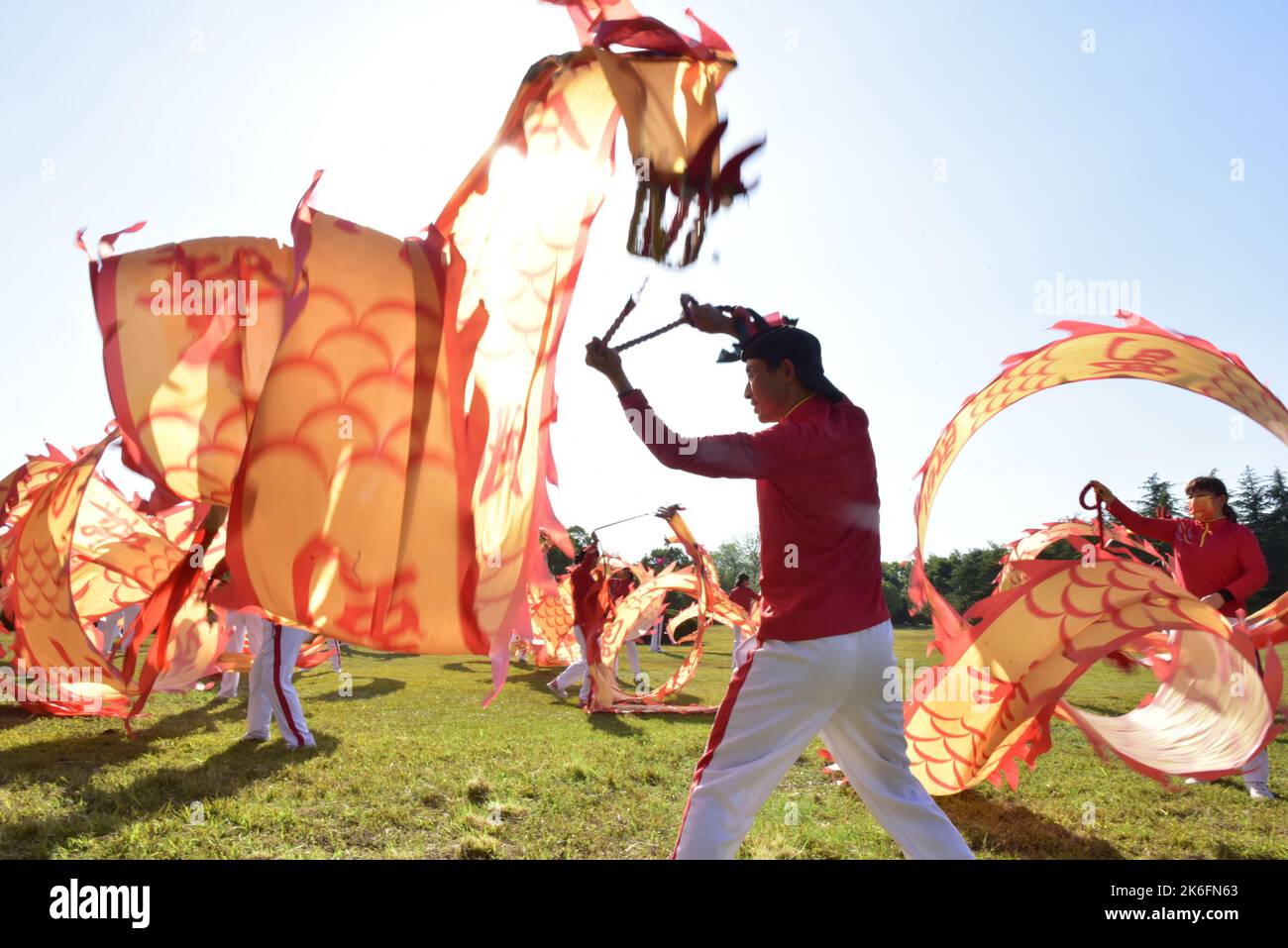 HEFEI, CHINA - OCTOBER 13, 2022 - Dragon dance lovers wave streamers as ...