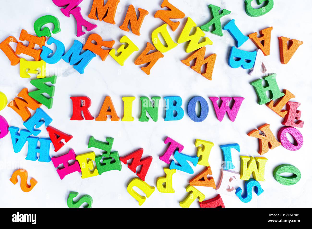 Word RAINBOW framed with colorful wooden letters on gray. Vivid ...