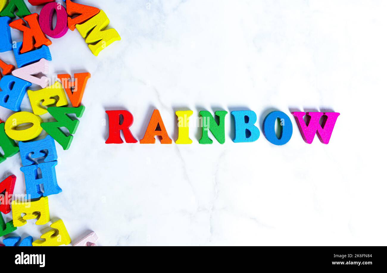 Colorful wooden letters arranged into a RAINBOW word. Bright learning ...