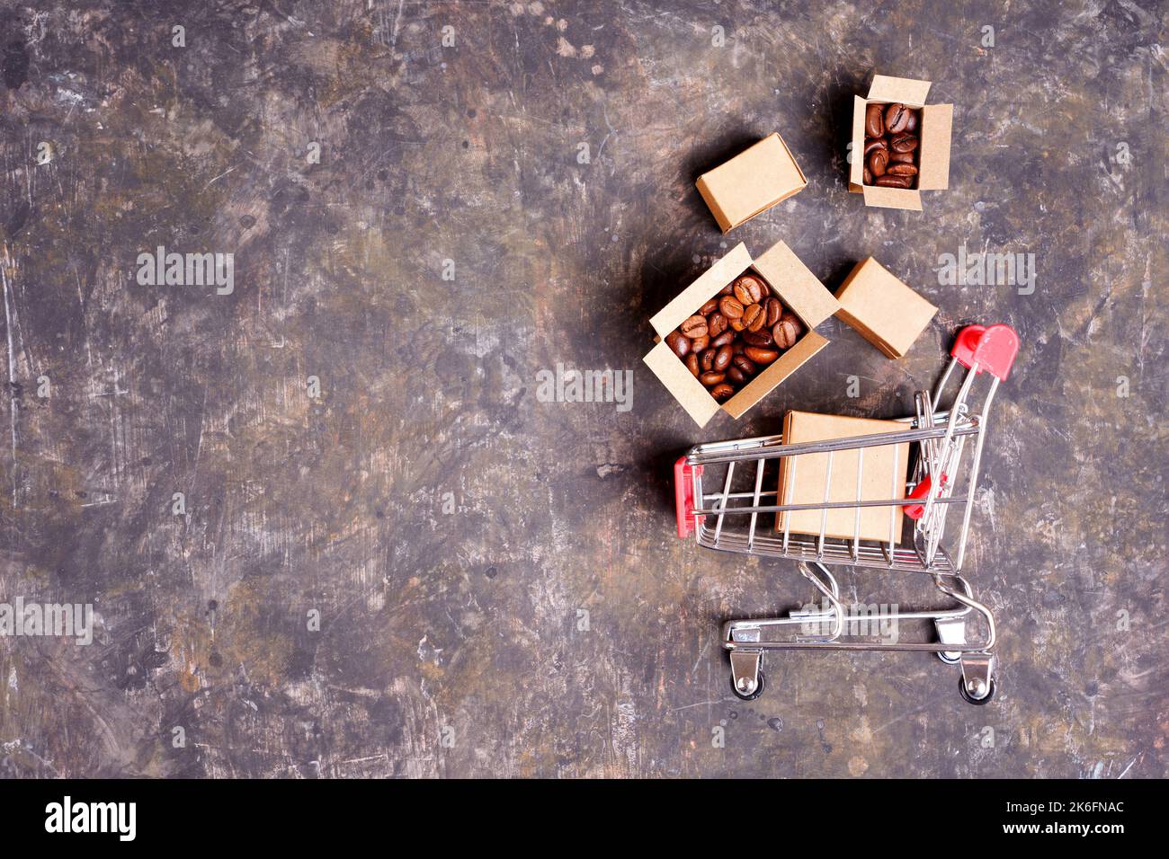 Overturned miniature push trolley and bunch of small cardboard boxes ...