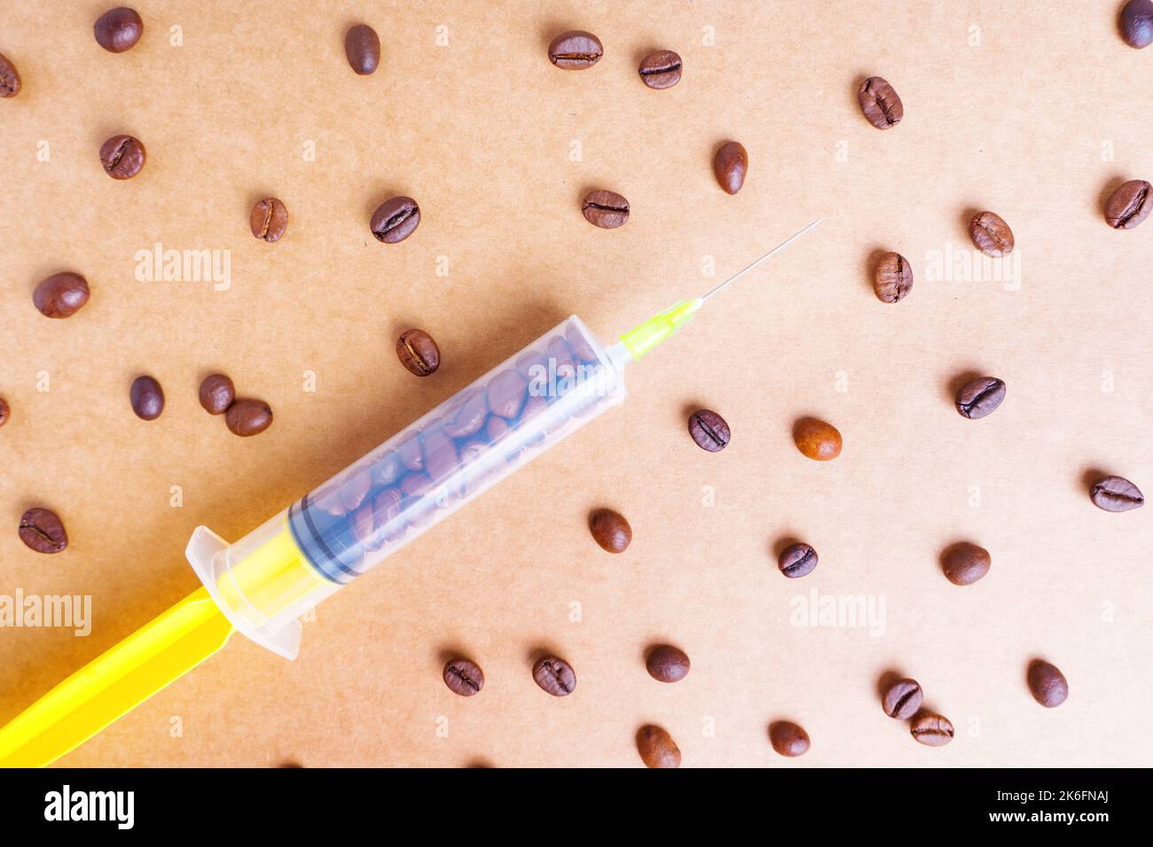 Roasted coffee beans and medical syringe background. Creative caffeine ...