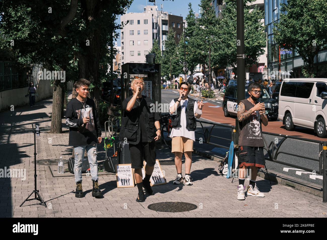 A group of J-pop singers playing rock on the street in Harajuku Tokyo ...