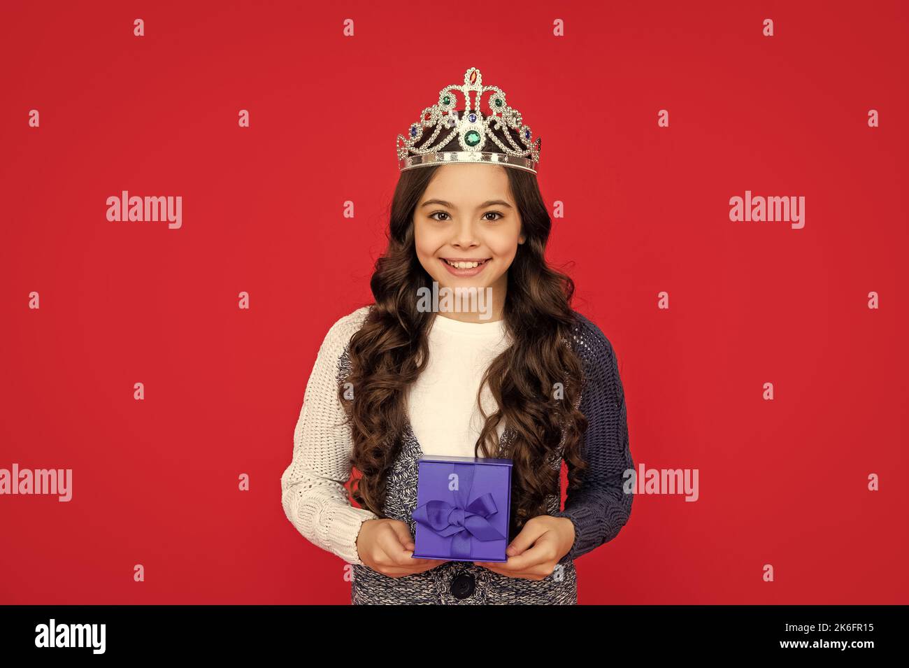 happy child in queen crown. princess in tiara hold box. kid with ...