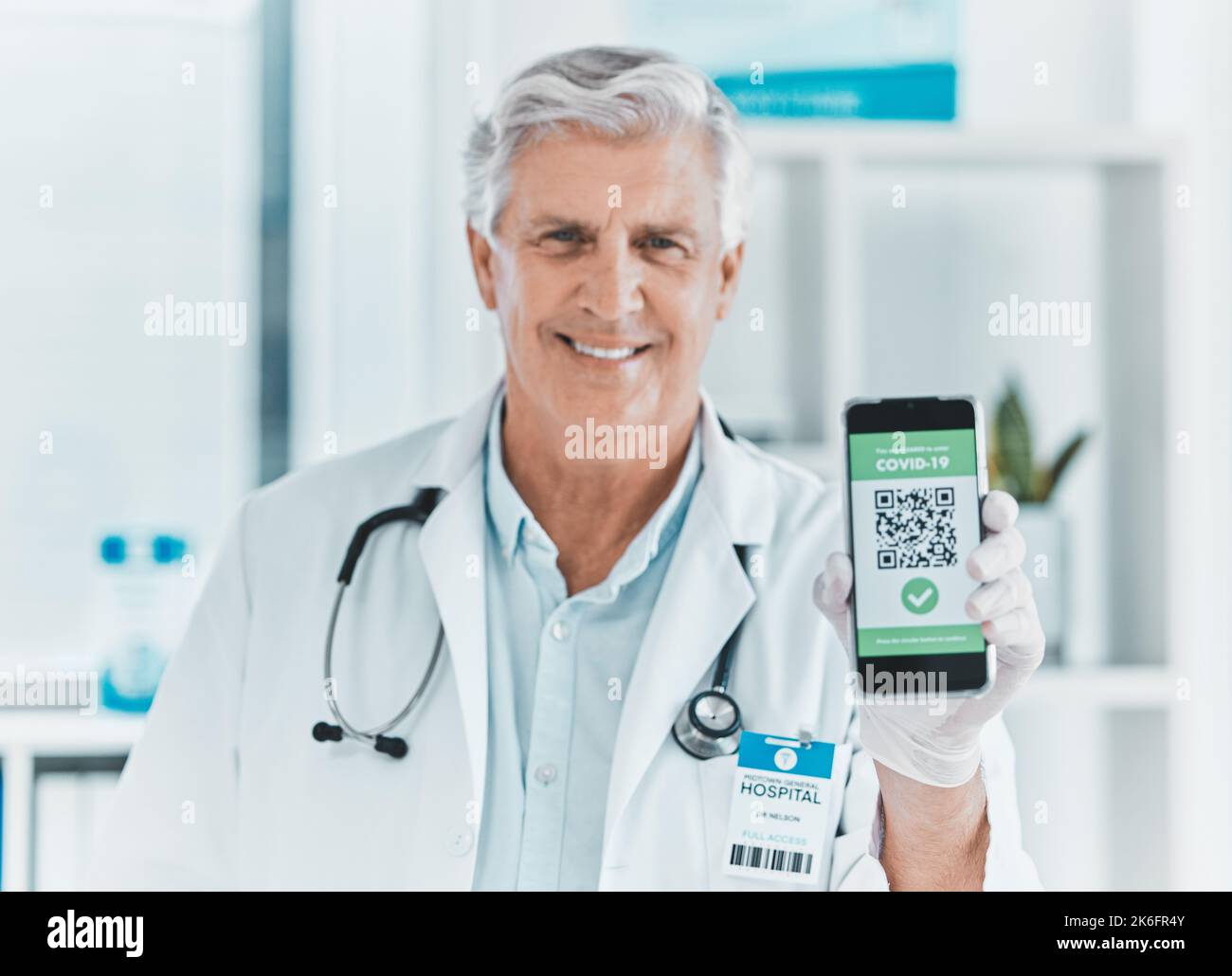 one tap is all it takes. a male doctor holding a smartphone depicting a ...