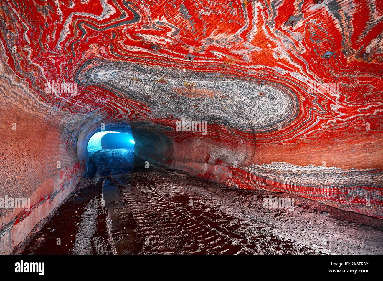 Outgoing tunnel of salt quarry with red patterns on walls Stock Photo ...
