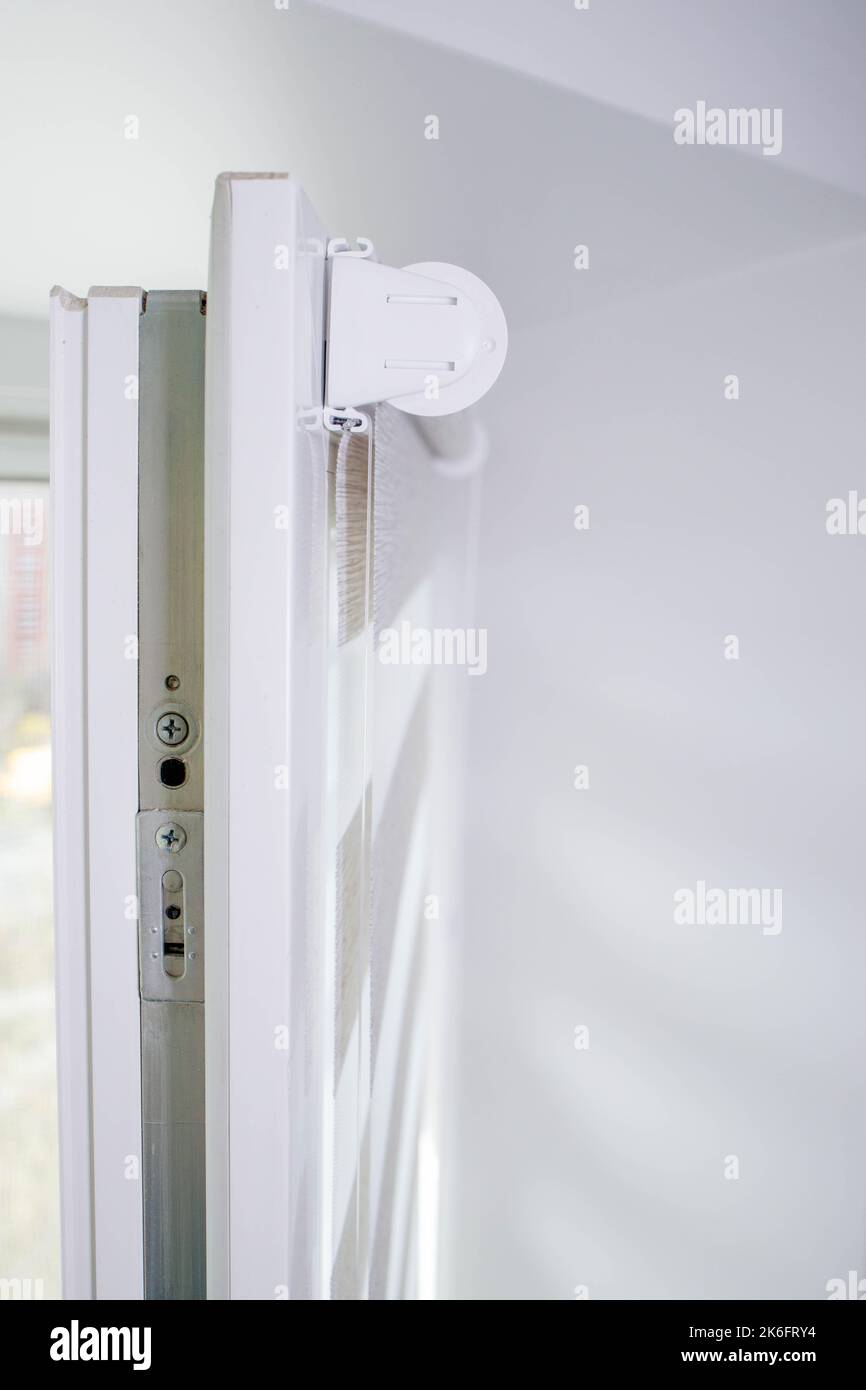 Close up mechanism of tnaninny roller blinds indoors. Duo window roller ...