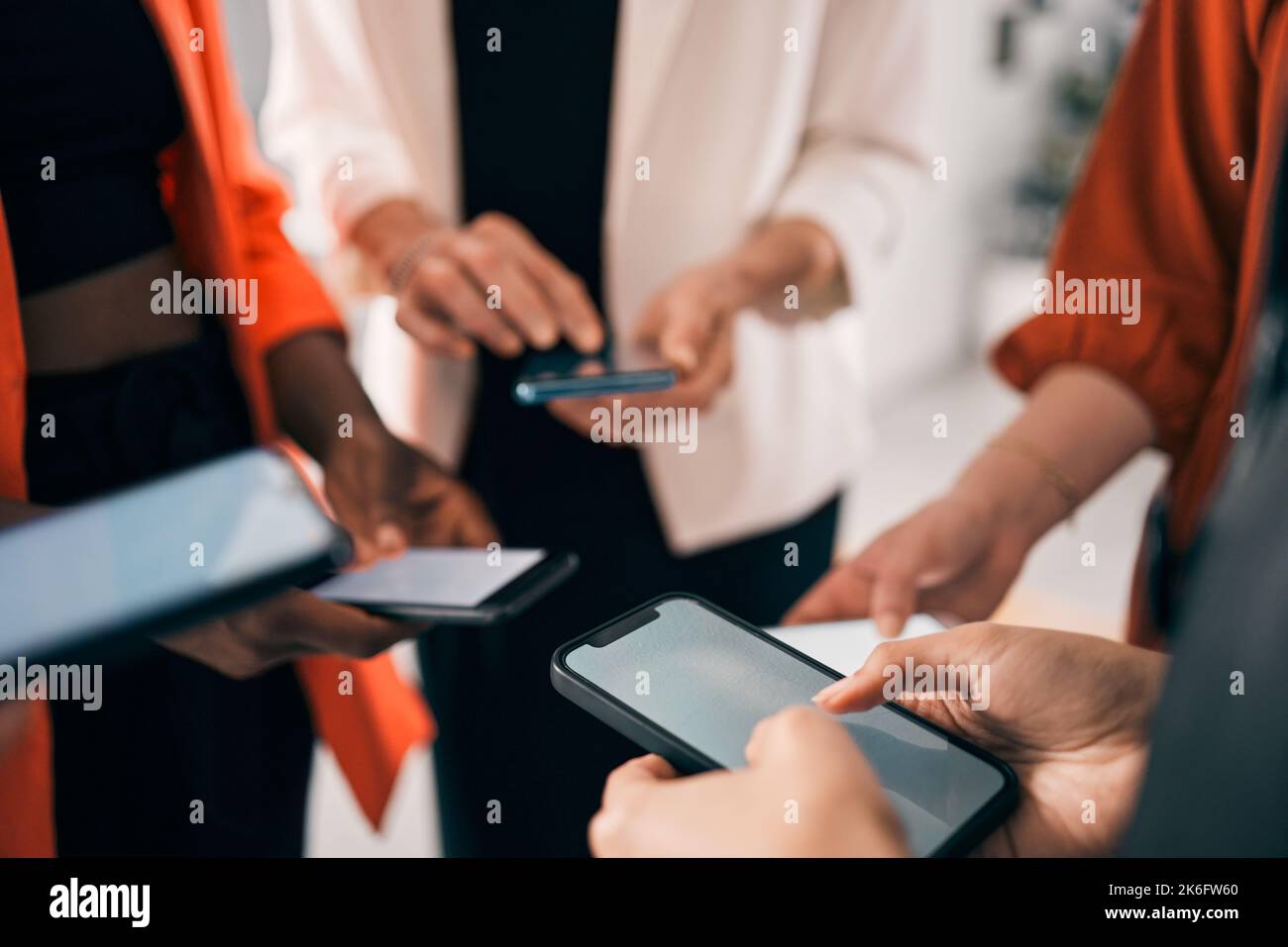 Whats new. a group of unrecognizable businesspeople using their phones ...