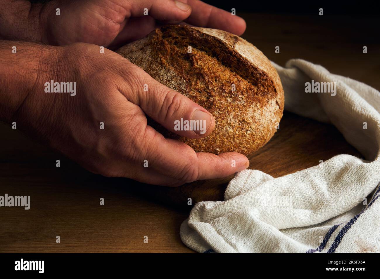 black bread in men's hands Stock Photo - Alamy