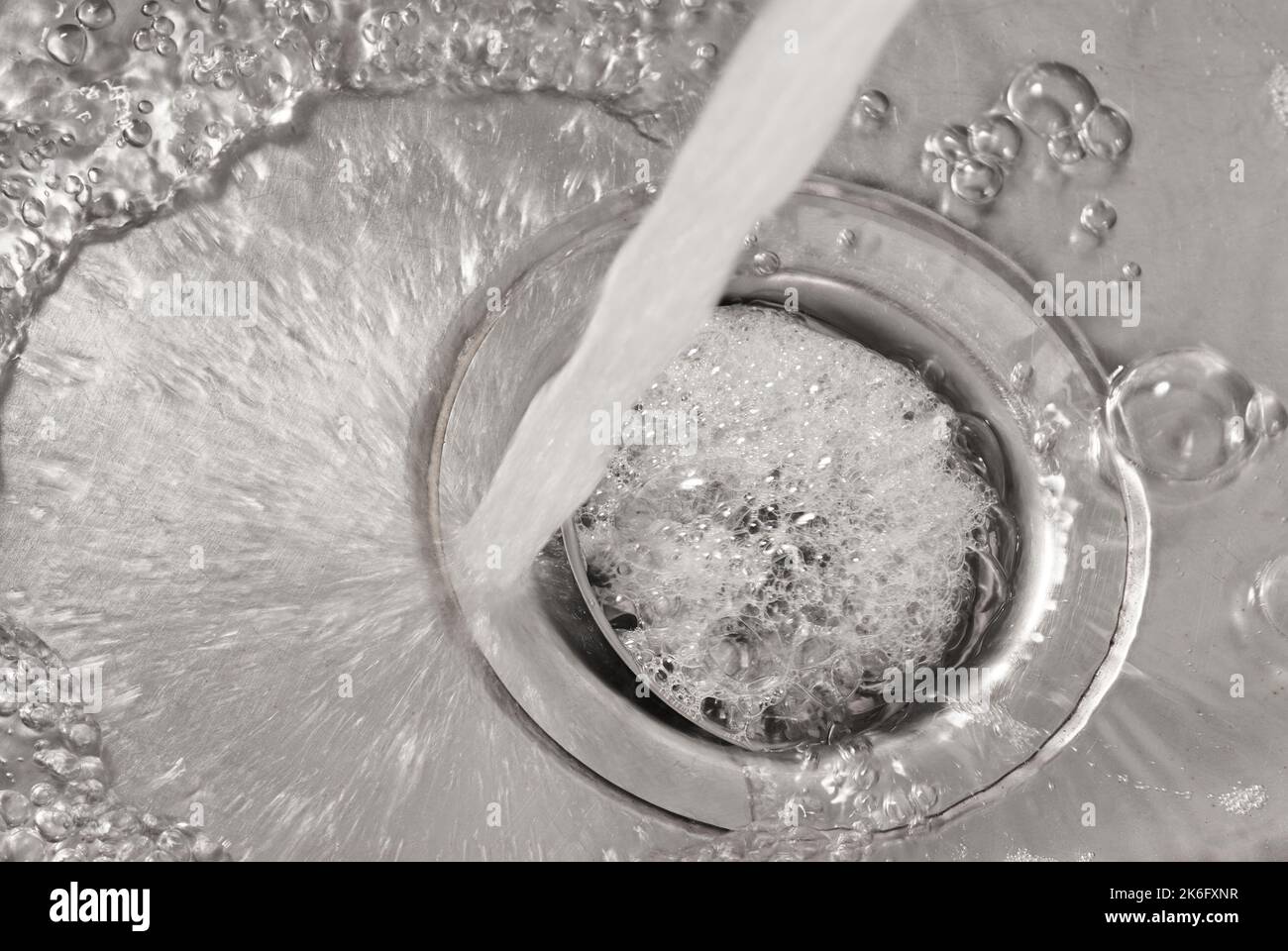 Detail of water jet falling down a drain Stock Photo - Alamy
