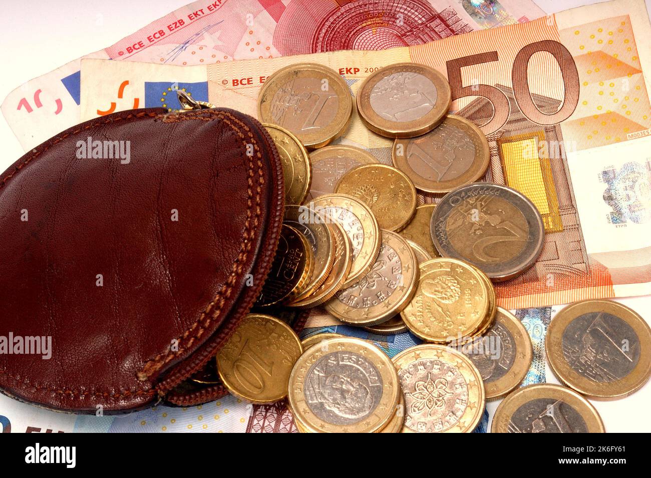 Different euro coins coming out of wallet on bills Stock Photo - Alamy