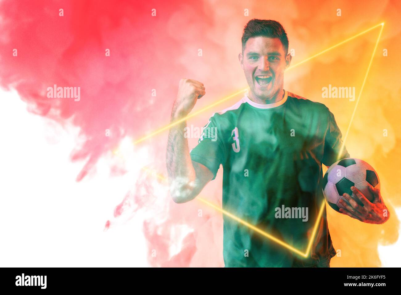 Male caucasian player holding ball and screaming with illuminated ...