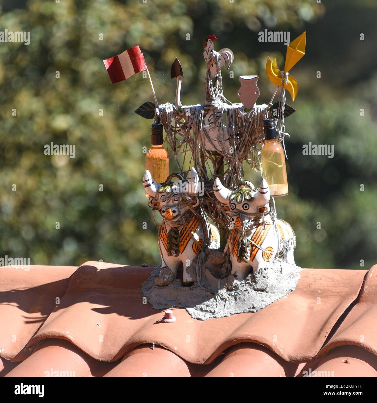 Traditional 'Toritos de Pucaca' sit on a rooftop in the rural Cusco ...