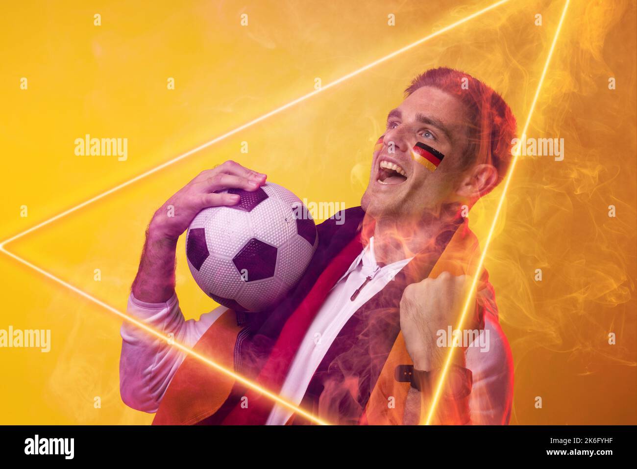 Male caucasian player holding german flag and ball screaming over ...
