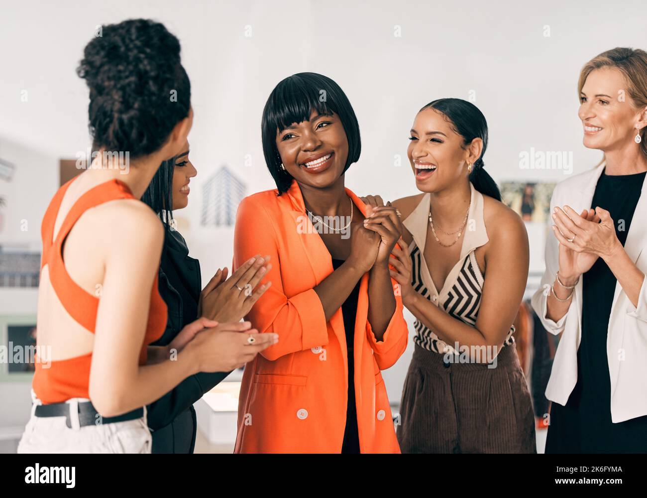 Stepping into my greatness. a group of young businesswomen clapping for ...