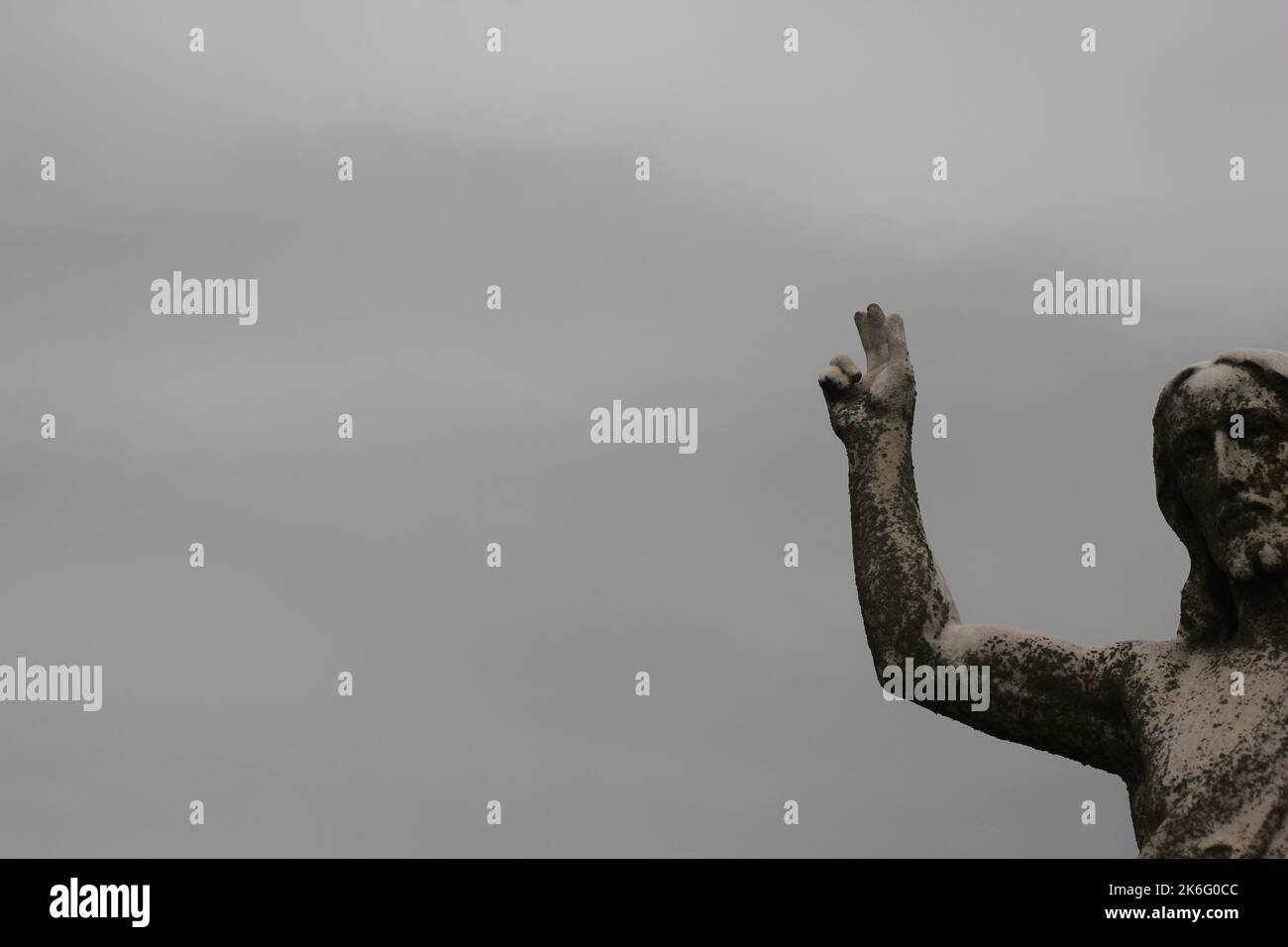 Stone statue of Jesus Christ standing and pointing up Stock Photo - Alamy