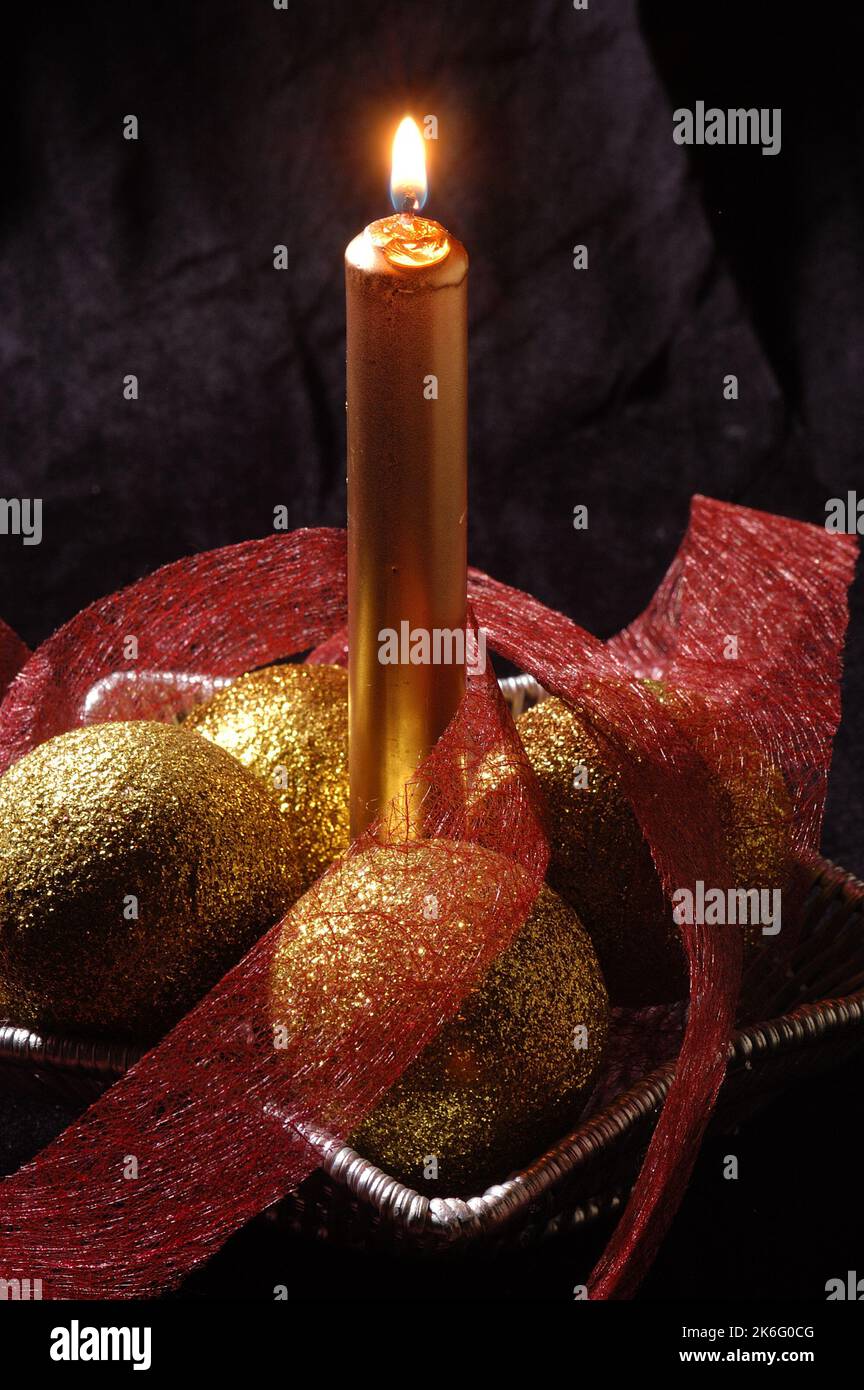 Lit candle and christmas balls Stock Photo - Alamy