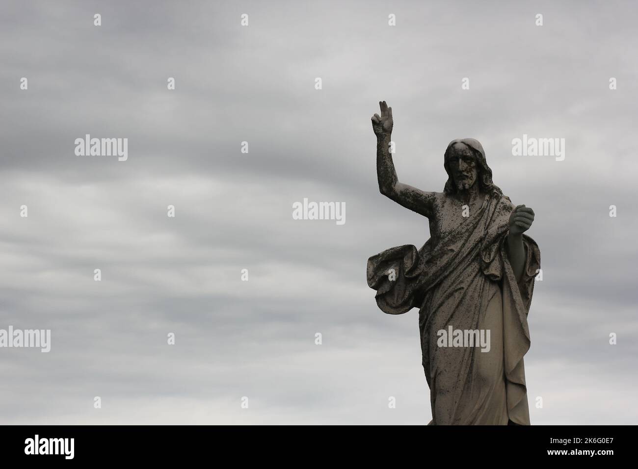 Stone statue of Jesus Christ standing and pointing up Stock Photo - Alamy