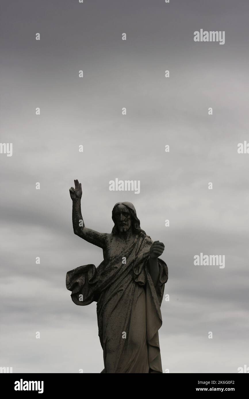 Stone statue of Jesus Christ standing and pointing up Stock Photo - Alamy