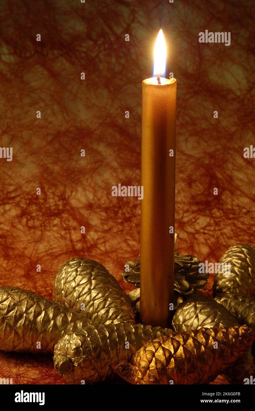 Lit candle with christmas decoration Stock Photo - Alamy