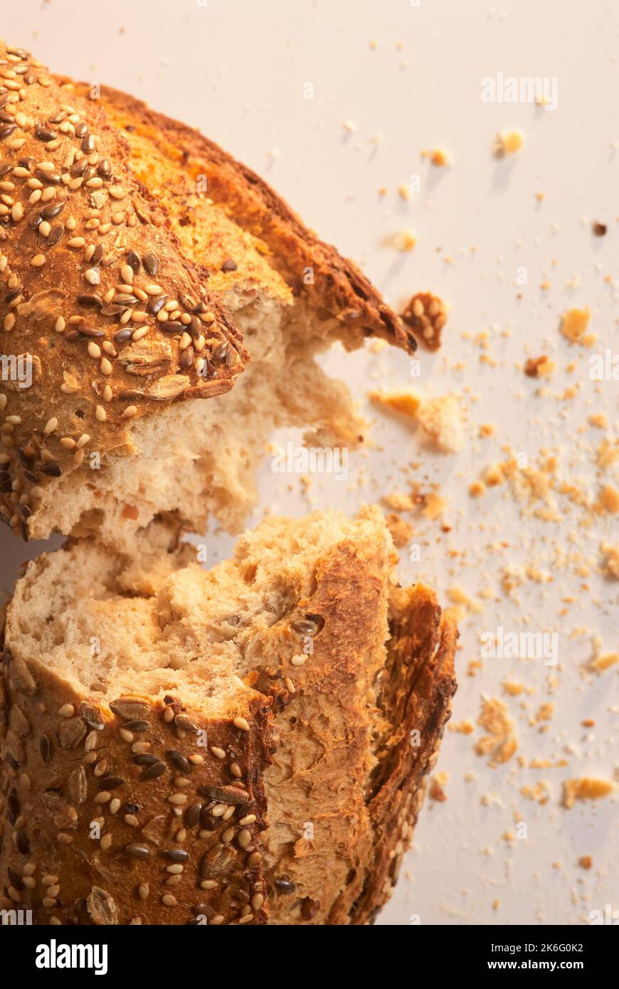 Bitten and cut bread with crumbs around Stock Photo - Alamy