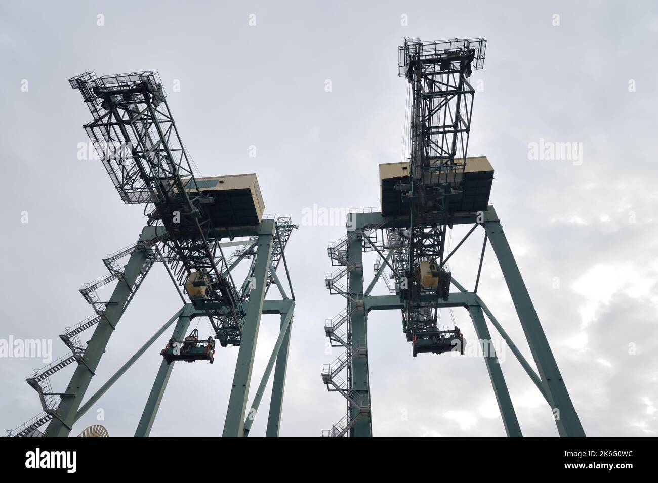 Large cranes in the loading area of a port Stock Photo - Alamy