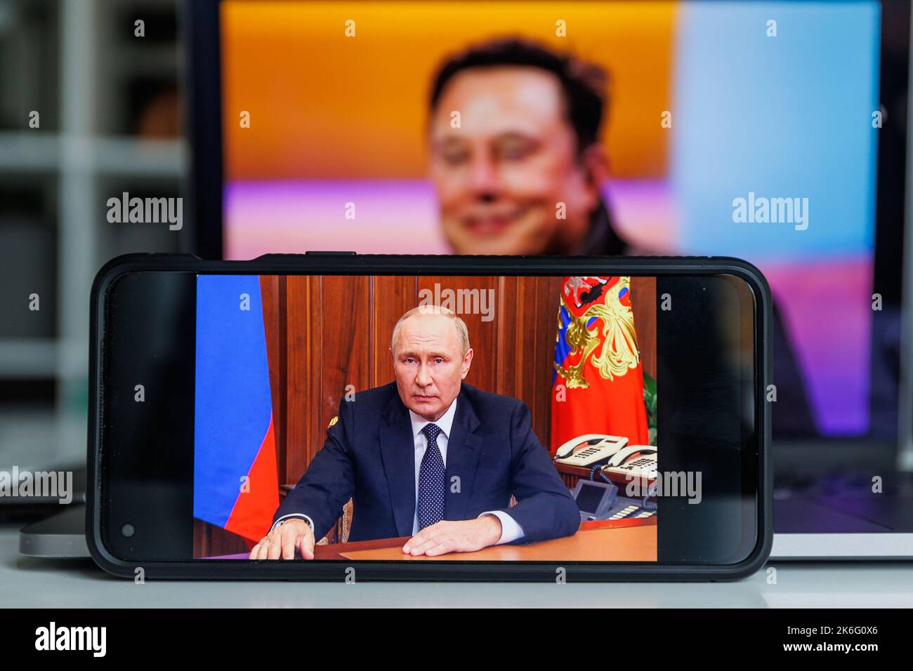 Vilnius, Lithuania - 2022 October 13: Elon Musk on screen and Vladimir ...