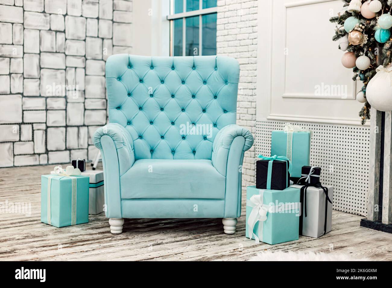 Gifts in boxes and a blue chair in the New Year's interior Stock Photo ...