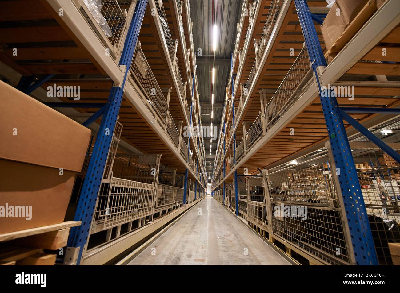 Aisle with shelves in a warehouse Stock Photo - Alamy
