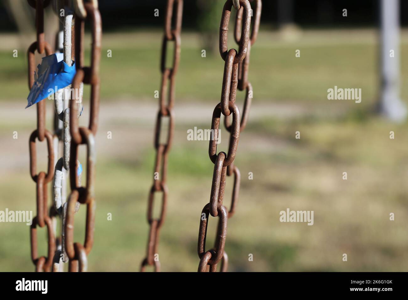 Heavy industrial steel metal chains hanging in the meadow Stock Photo ...