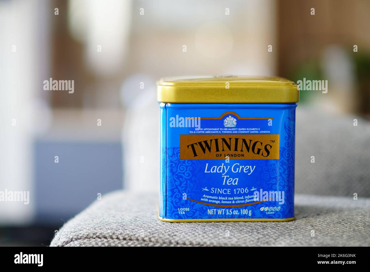 A closeup of Twinings brand Lady Grey Tea isolated on a sofa in a room ...