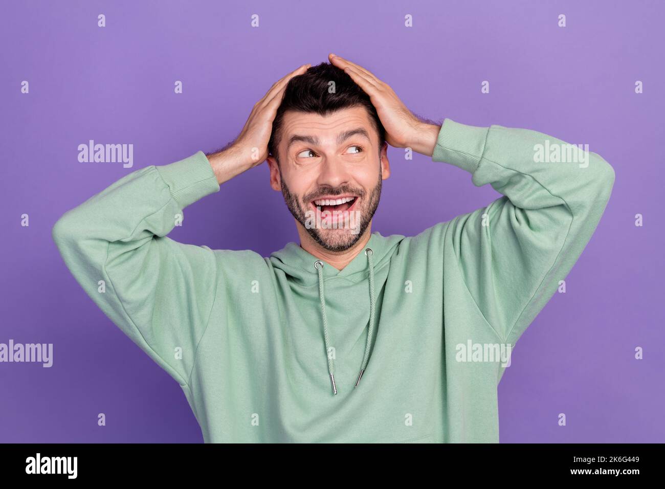 Photo of young excited cute positive student man stubble touch his head ...