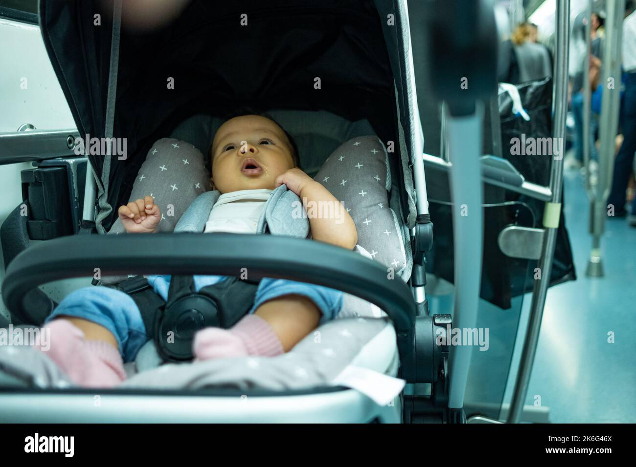 Baby in stroller in the subway. A baby inside a pram in public ...