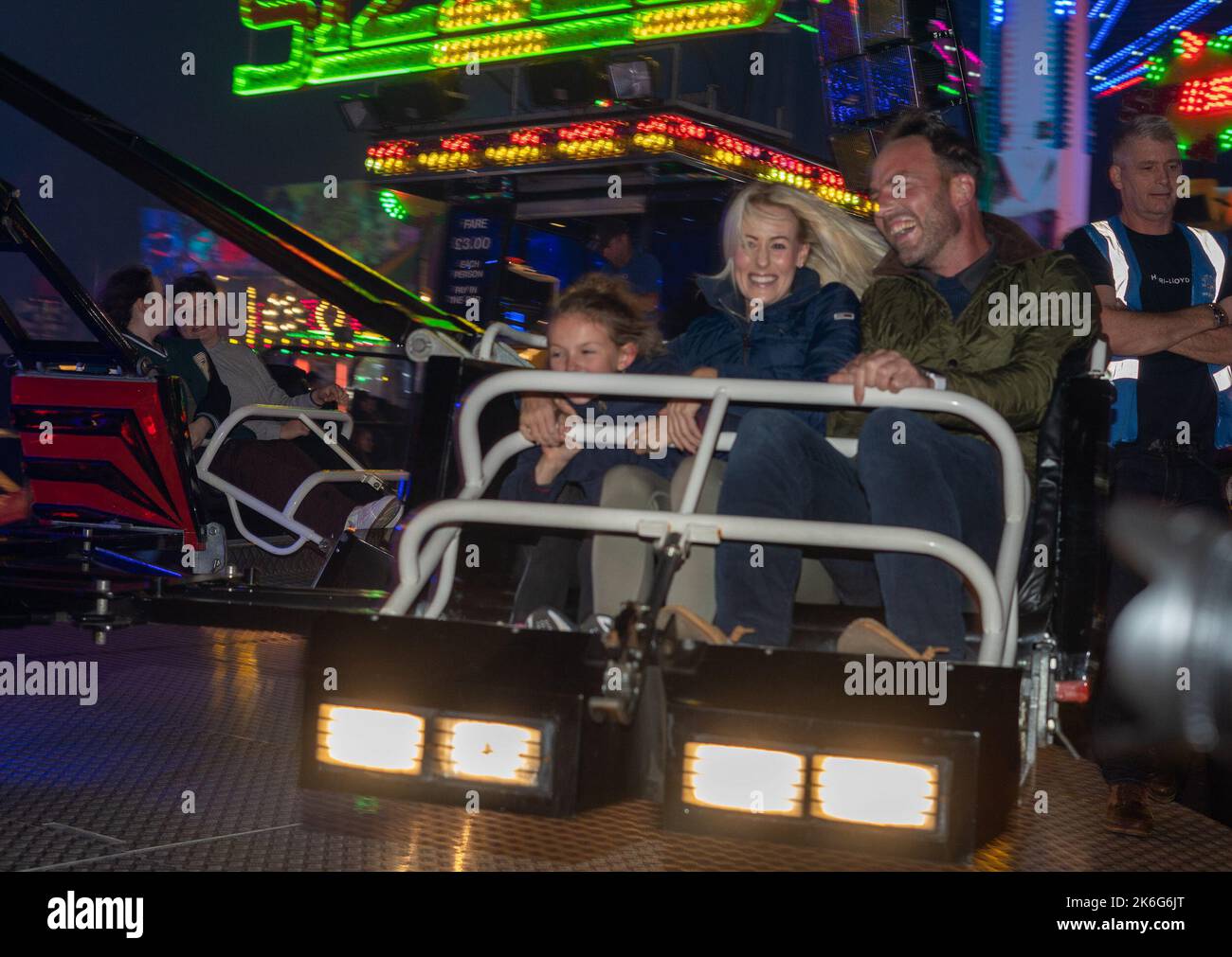 Oct 8th 2022, Tewkesbury Mop Fair, England. Two adults and a girl are ...